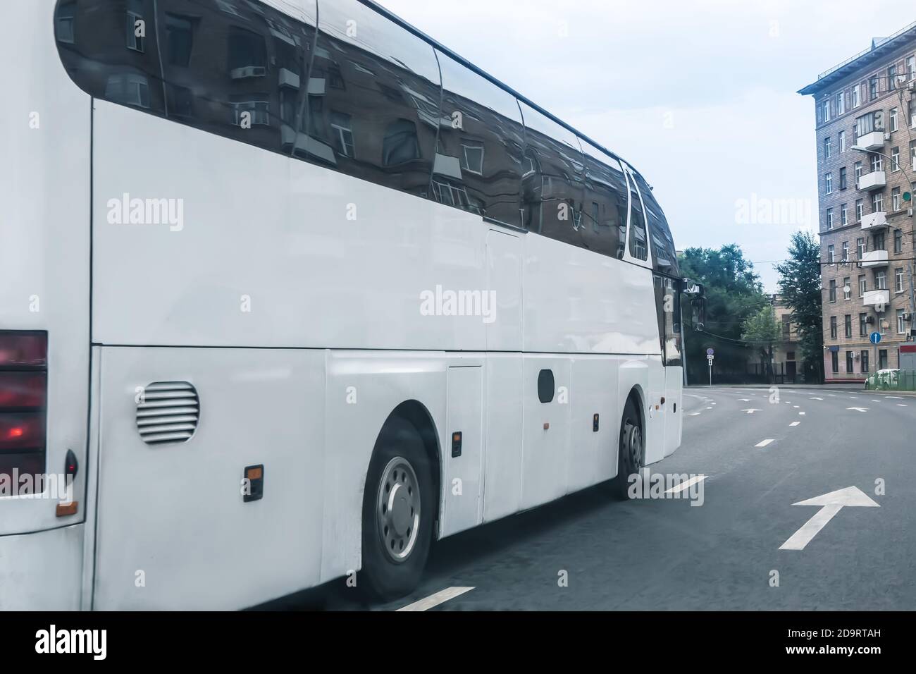white tourist bus goes on the city street Stock Photo - Alamy