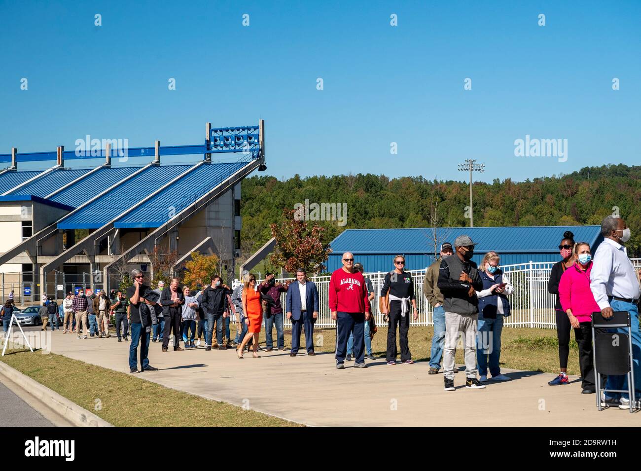 Voters waiting in line outside of a polling station Stock Photo - Alamy