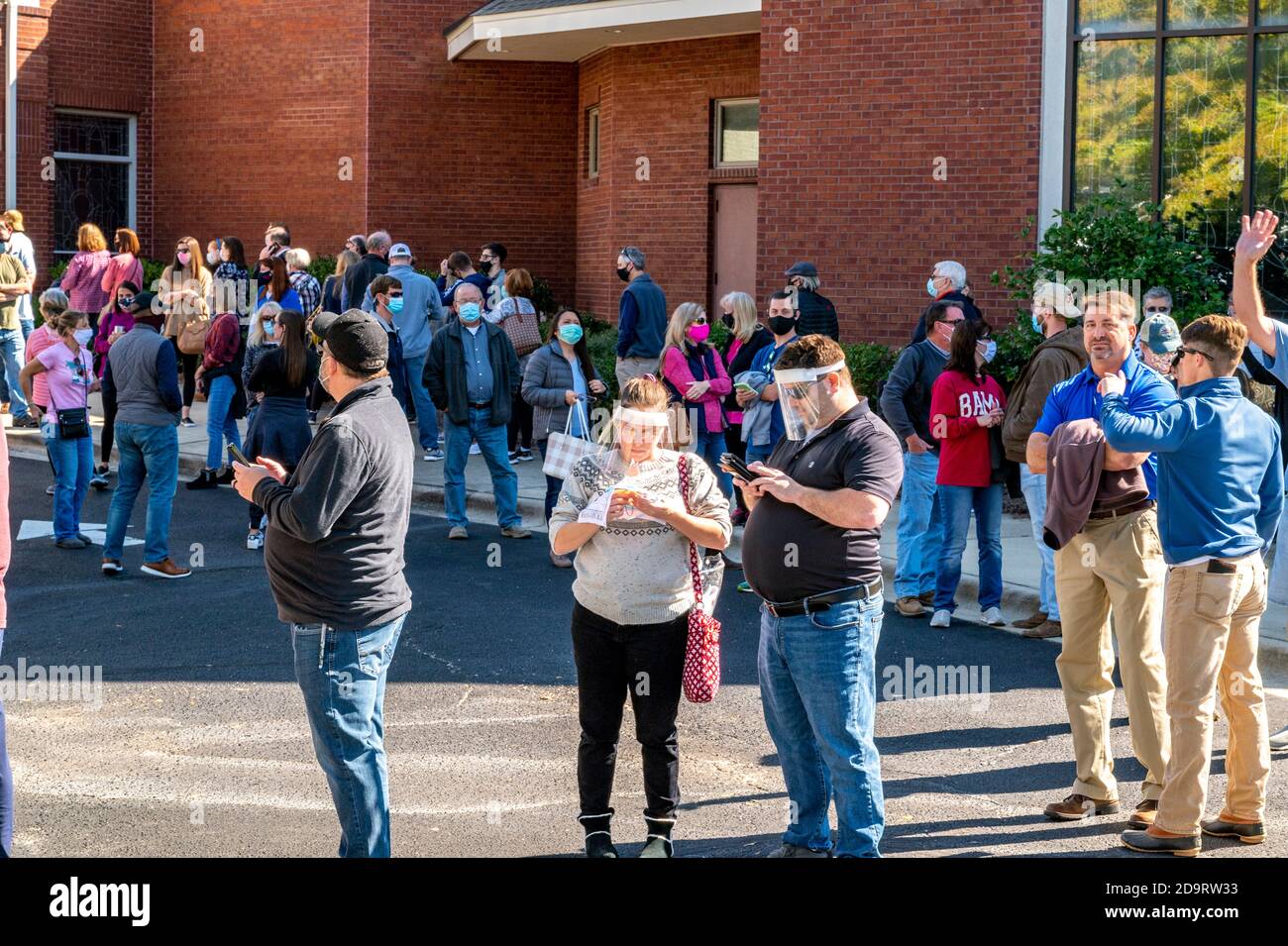 Voters waiting in line outside of a polling station Stock Photo - Alamy