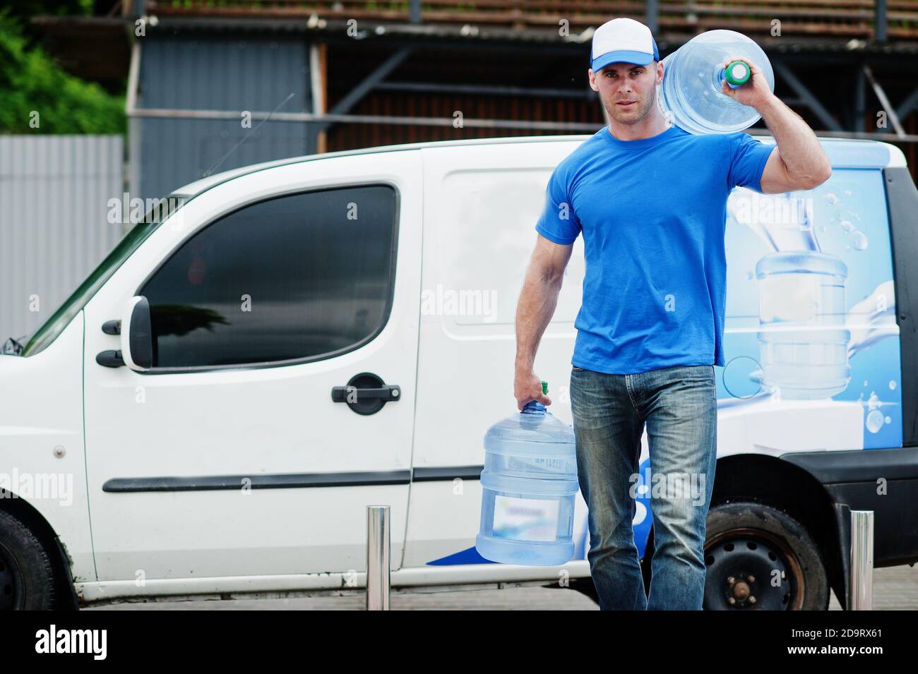 Delivery men in front cargo van delivering bottles of water Stock Photo ...