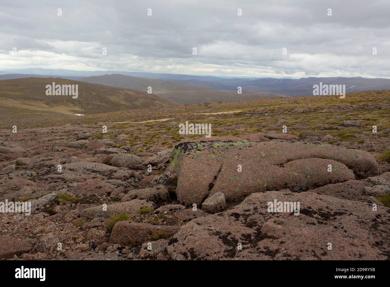 View of mountains and boulder fields from summit of Cairn Gorm ...