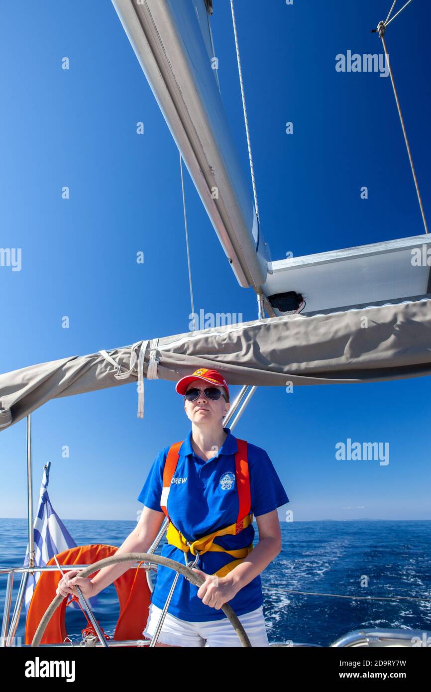 Greece. Corfu 25 October 2016: Young woman drives sailing yacht Stock ...