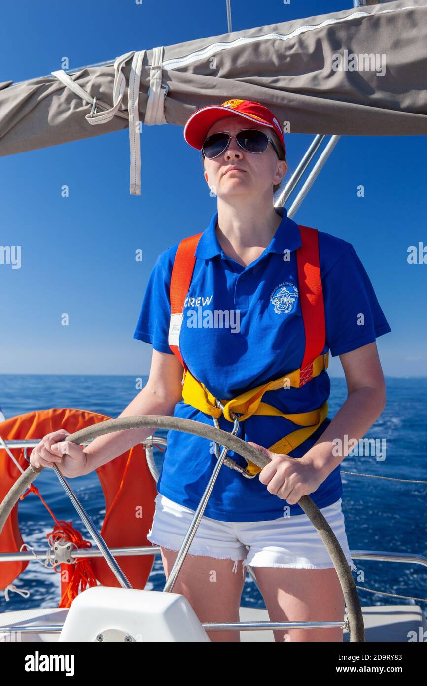 Greece. Corfu 25 October 2016: Young woman drives sailing yacht Stock ...