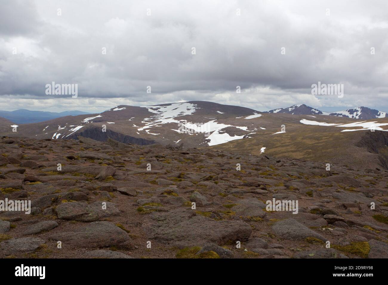 View of mountains and boulder fields from summit of Cairn Gorm ...