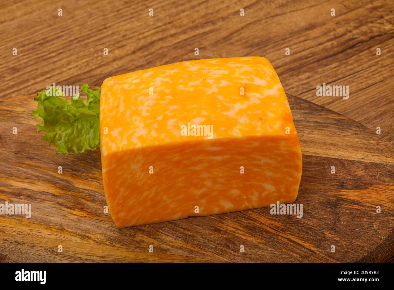 Dairy Marble cheese brick over board Stock Photo - Alamy