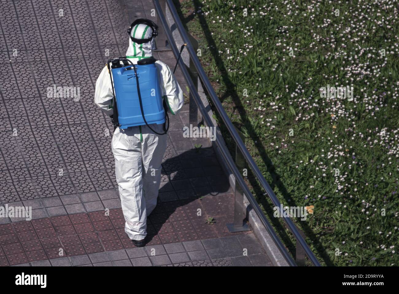 High angle aerial shot of a man sanitizing the park during Coronavirus ...