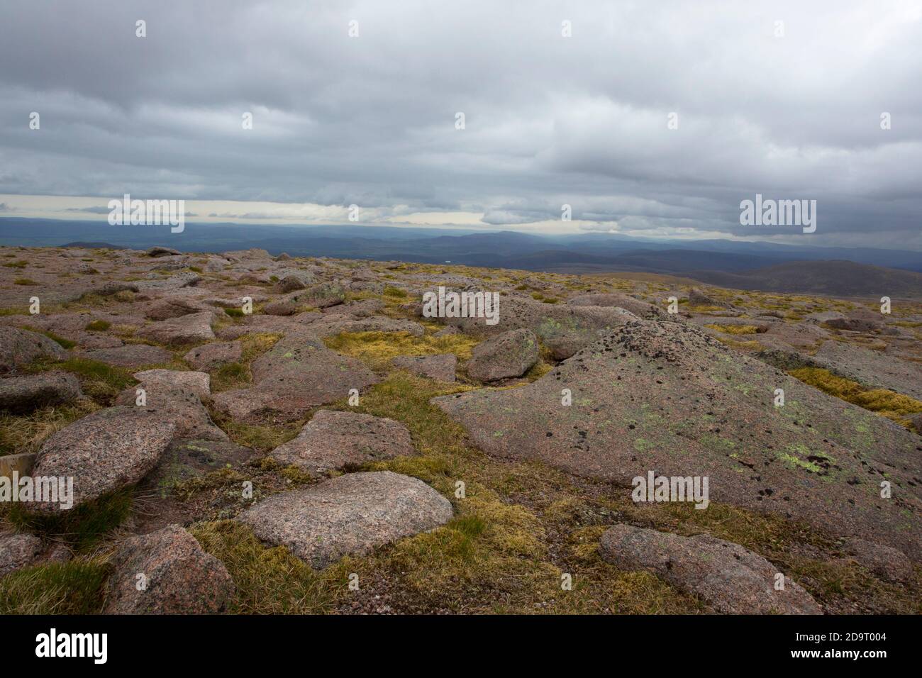 View of mountains and boulder fields from summit of Cairn Gorm ...