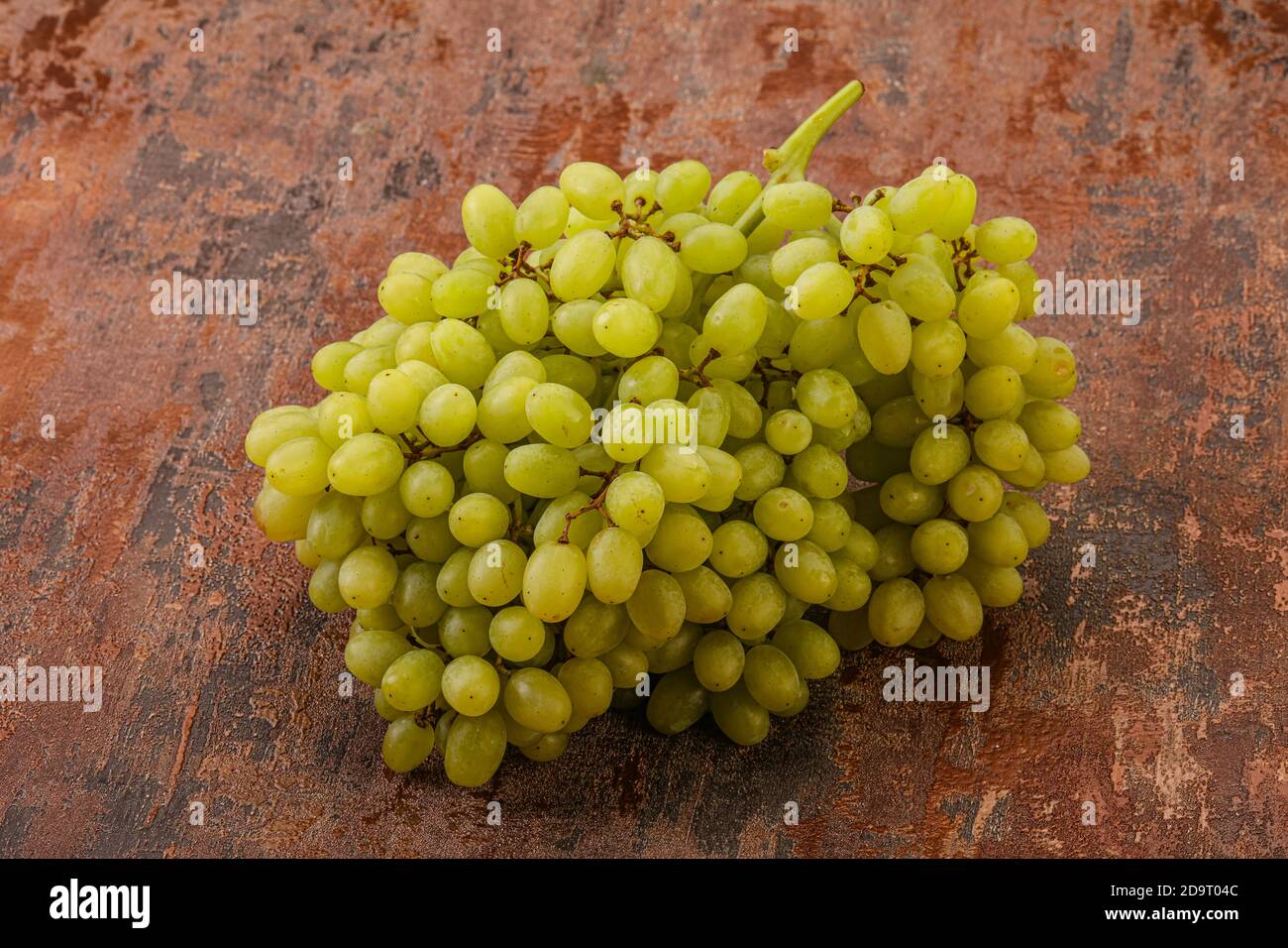 Sweet Green grape branch over background Stock Photo - Alamy