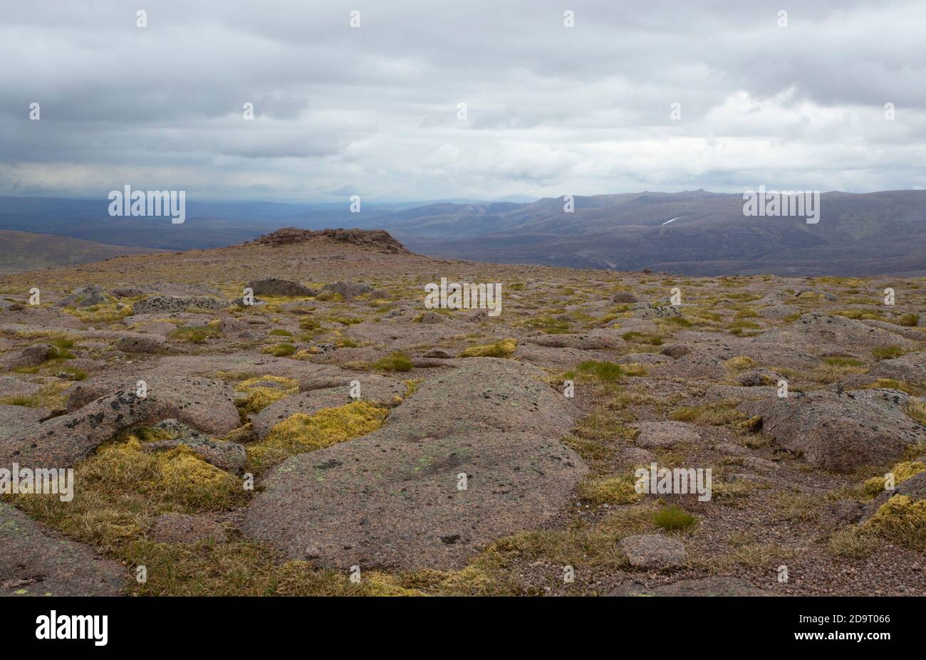 View of mountains and boulder fields from summit of Cairn Gorm ...