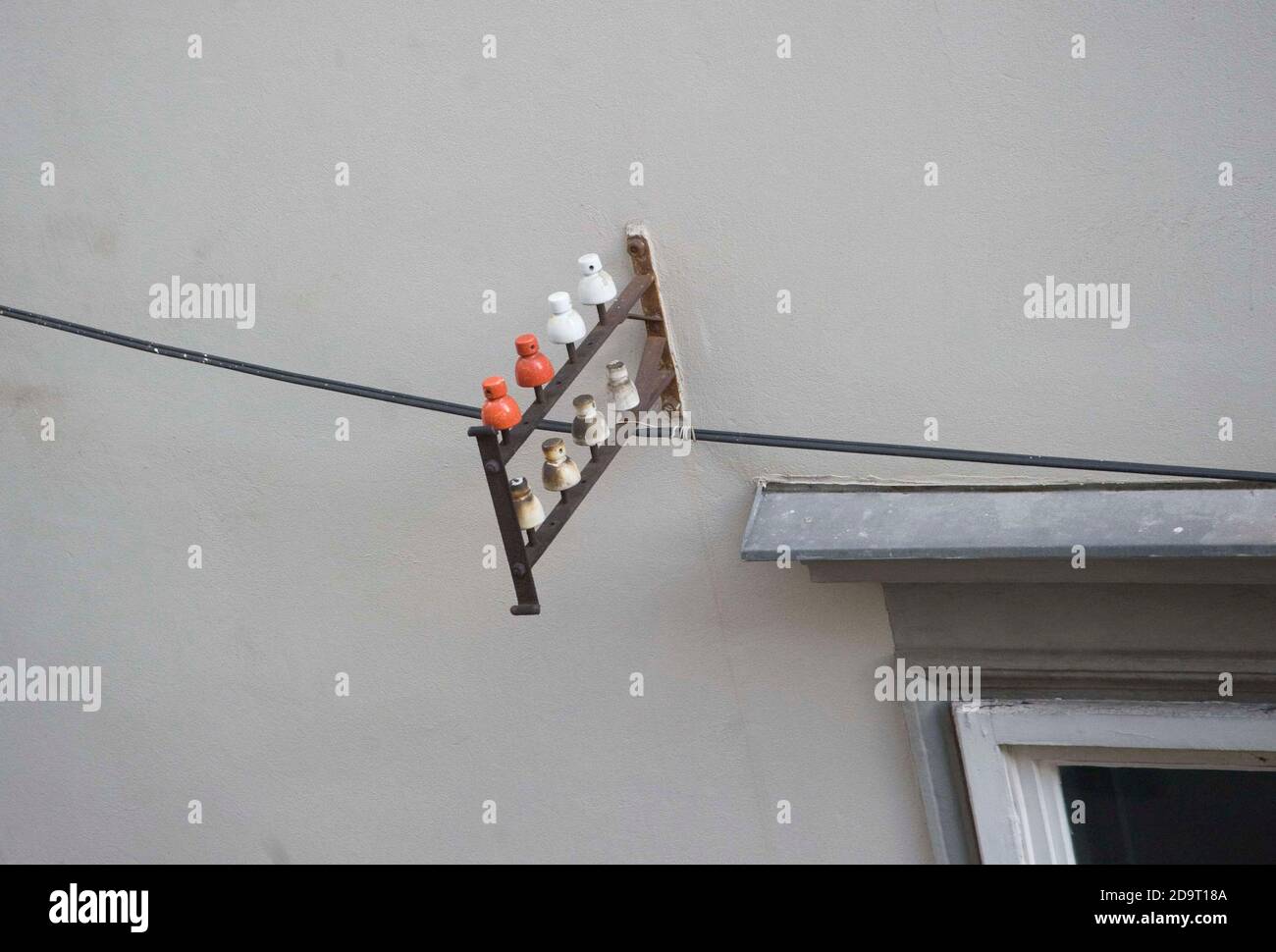 a ceramic insulator mounted on the wall of a building Stock Photo - Alamy