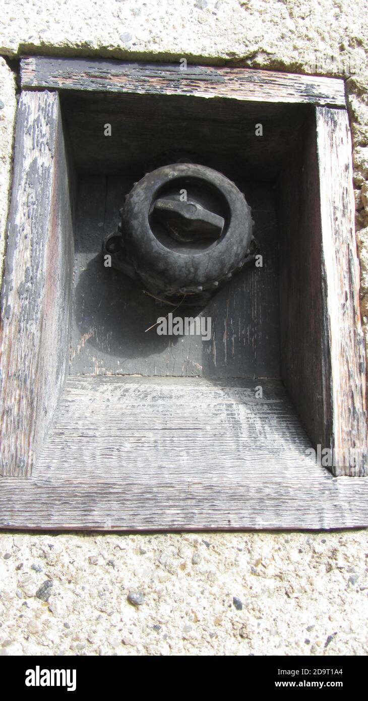 a black and vintage power switch in a wall of a building Stock Photo ...