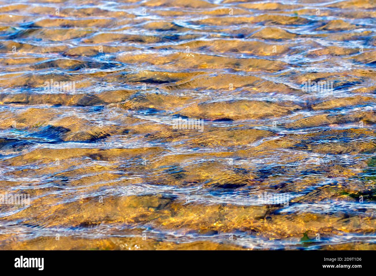 An abstract image of the ripples created by the wind on the water's ...