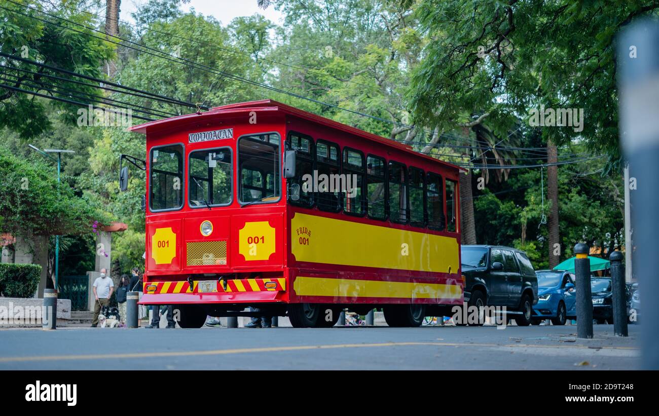 Low Angle View of a Red and Yellow Trolley Car Surrounded by Trees ...