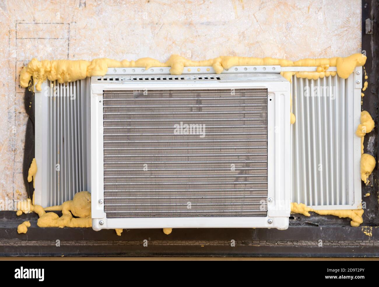 Air conditioning unit mounted to a piece of plywood. Lots of messy ...