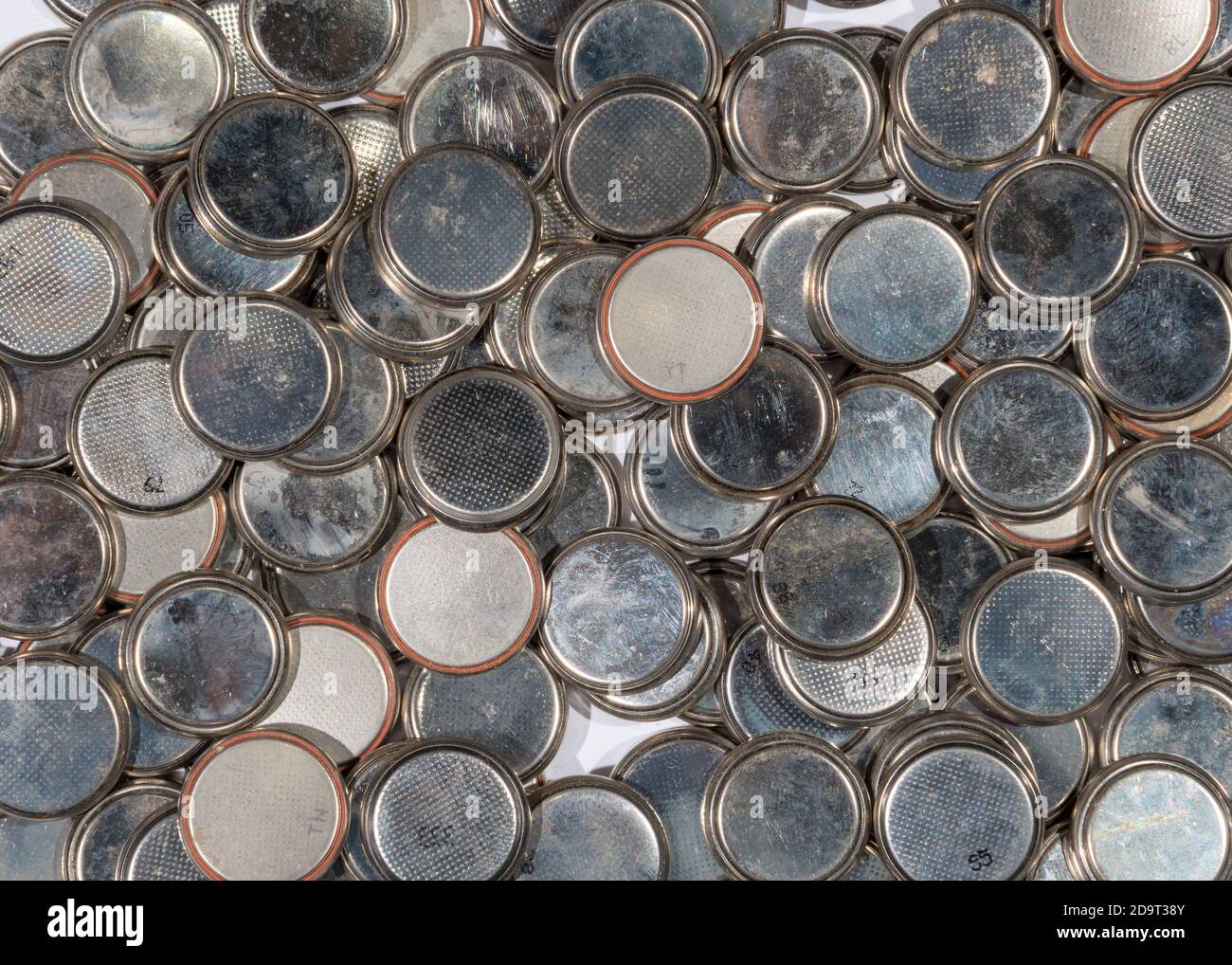 Pile of button batteries to be recycled. Batteries are old and dirty ...
