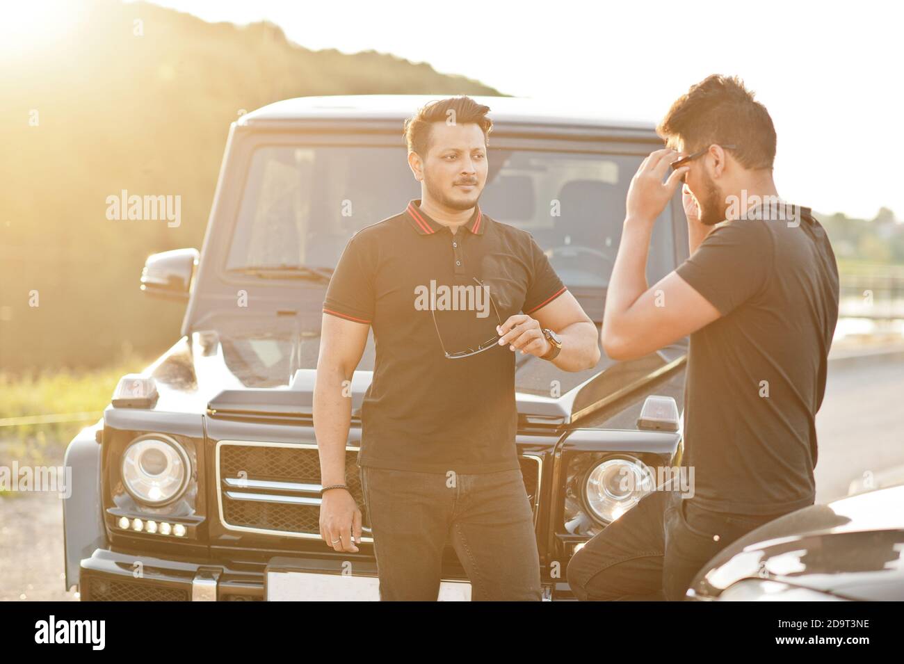 Two asian brothers man wear on all black posed near suv cars Stock ...