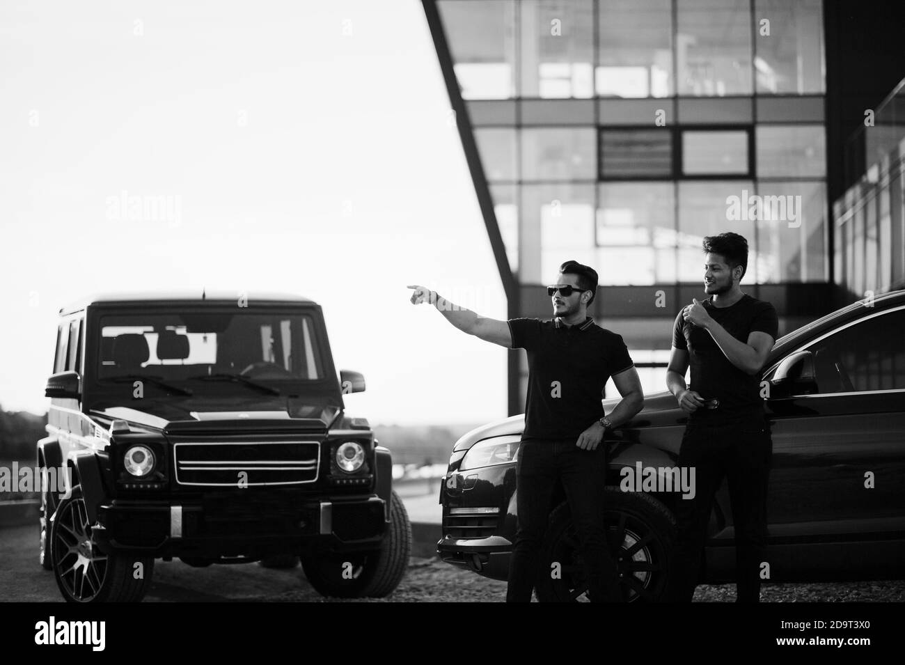 Two asian brothers man wear on all black posed near suv cars Stock ...