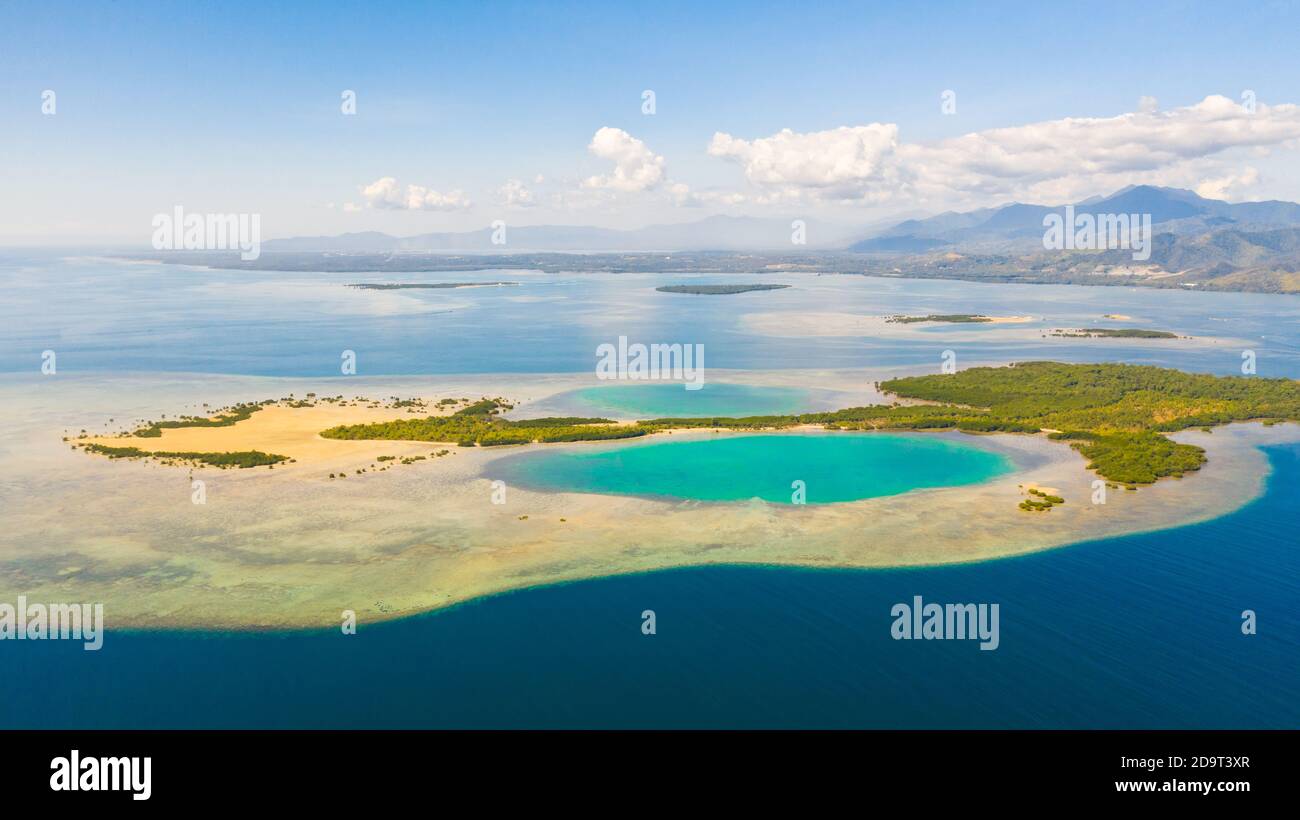 Tropical island with mangroves and turquoise lagoons on a coral reef ...
