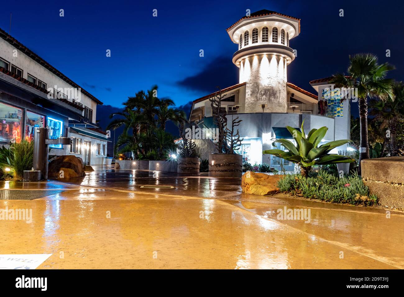 Ventura Harbor Village entrance is reflective and wet from the early ...