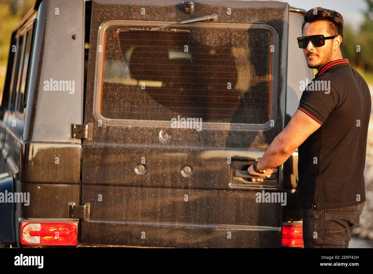 Asian man wear on all black posed near suv car, open rear door Stock ...