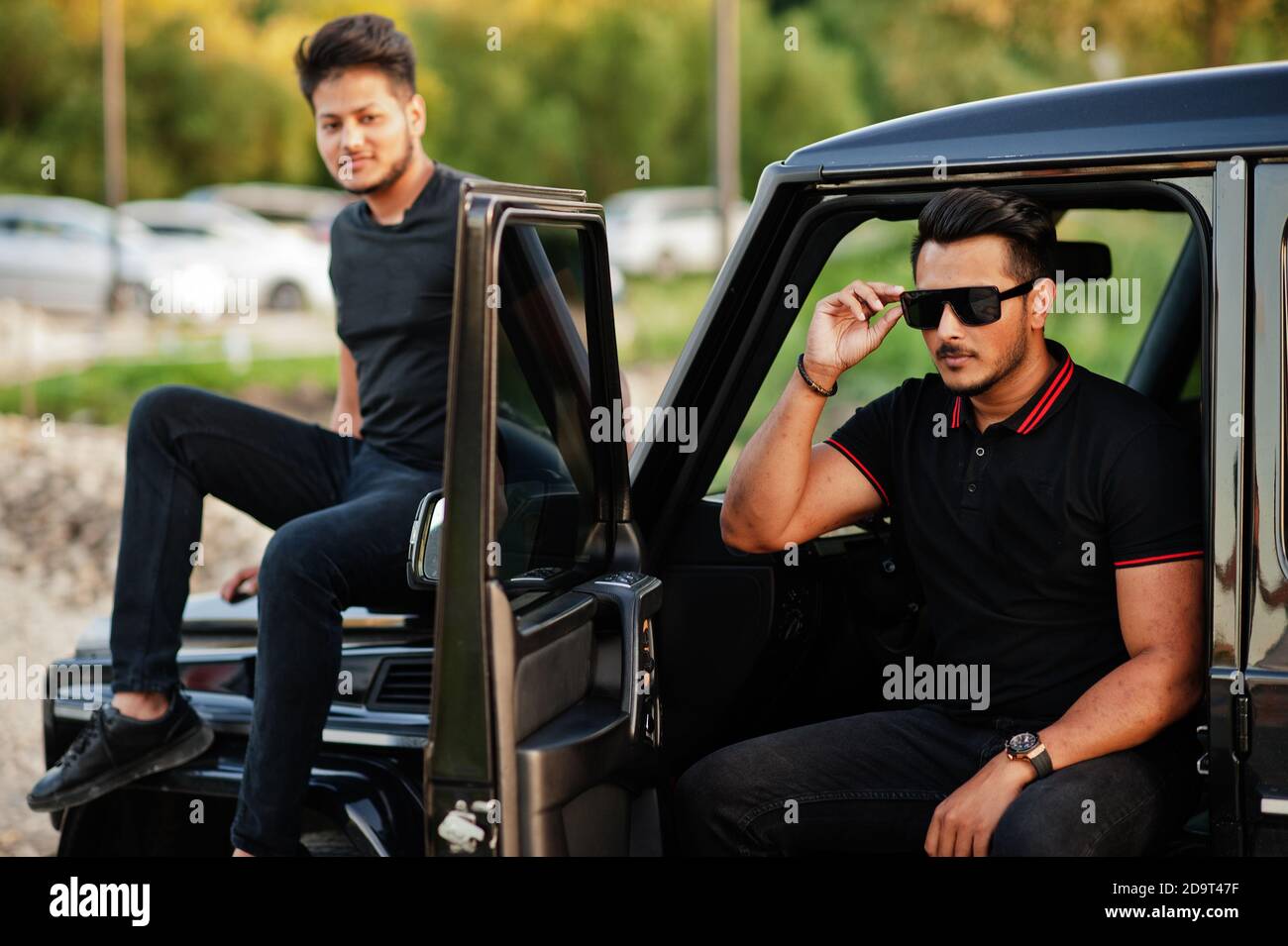 Two asian brothers man wear on all black posed near suv car Stock Photo ...
