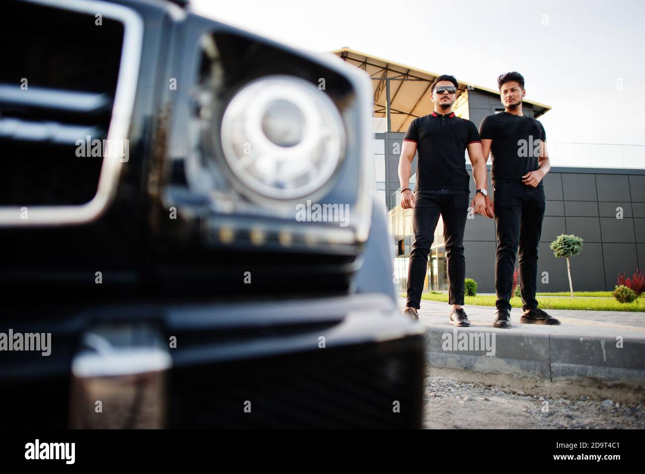 Two asian brothers man wear on all black posed near suv car Stock Photo ...