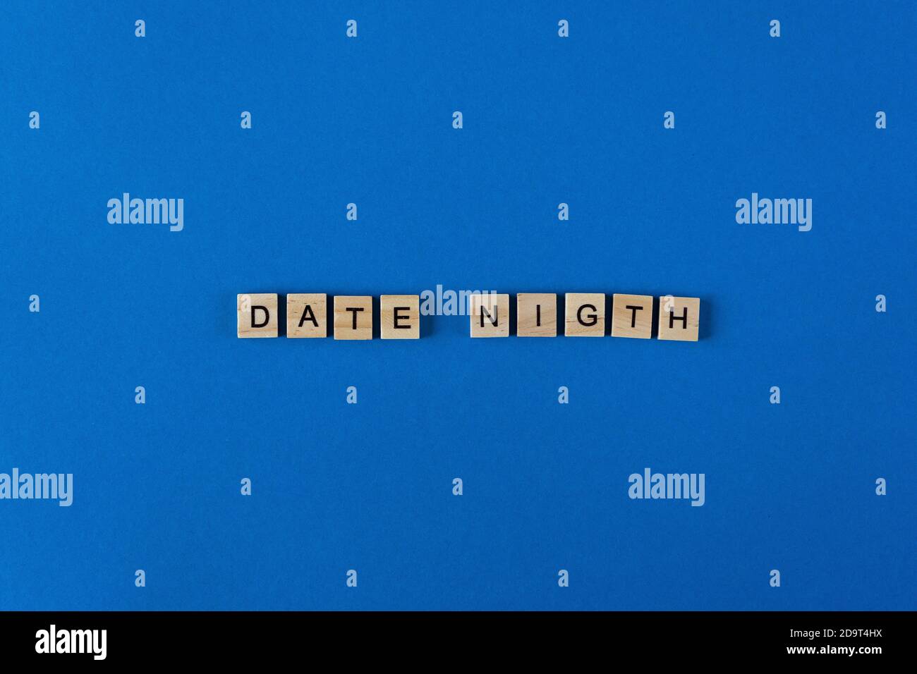 Date night - phrase slogan lined with wooden letters. Postcard with ...
