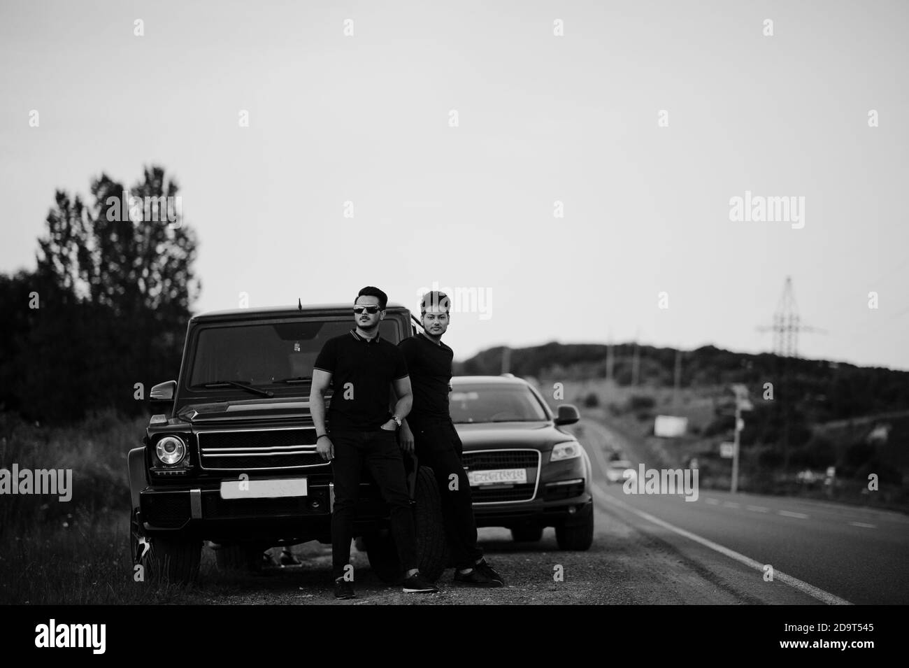 Two asian brothers man wear on all black posed near suv cars Stock ...