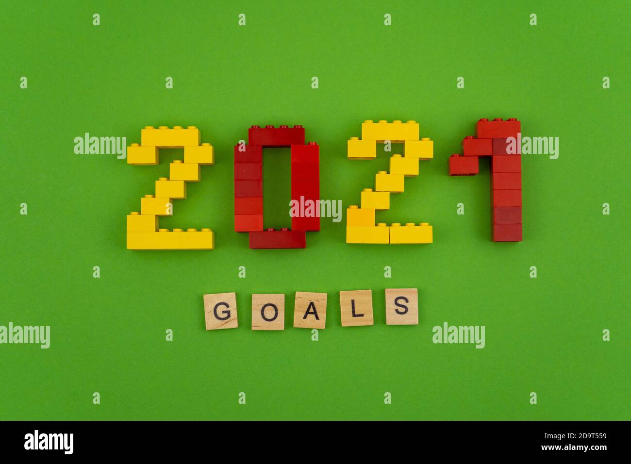 The word goal 2021 is lined with wooden letters on a green background ...