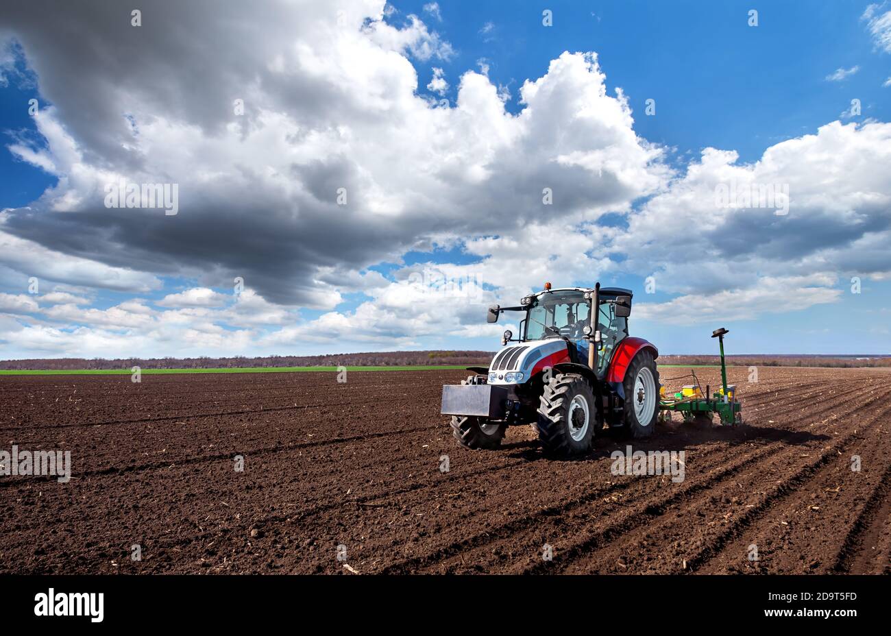 Farmer seeding, sowing crops at field Stock Photo - Alamy
