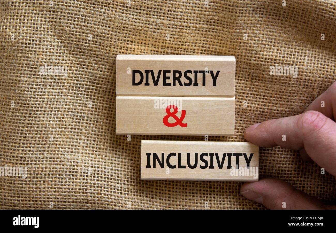 Wooden blocks form the words 'diversity and inclusivity' on canvas ...