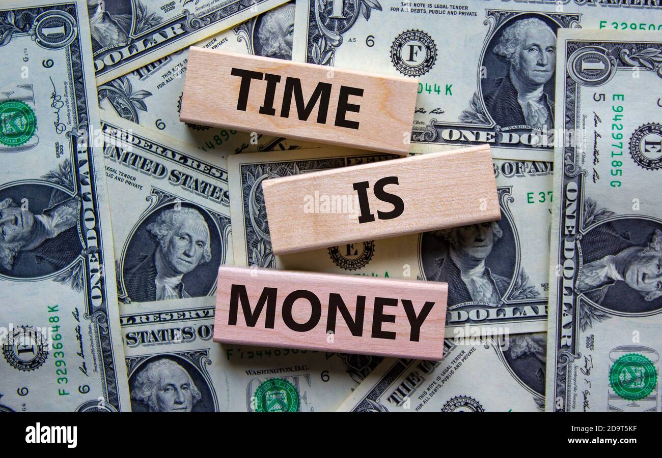 Wooden blocks form the words 'time is money' on beautiful background ...