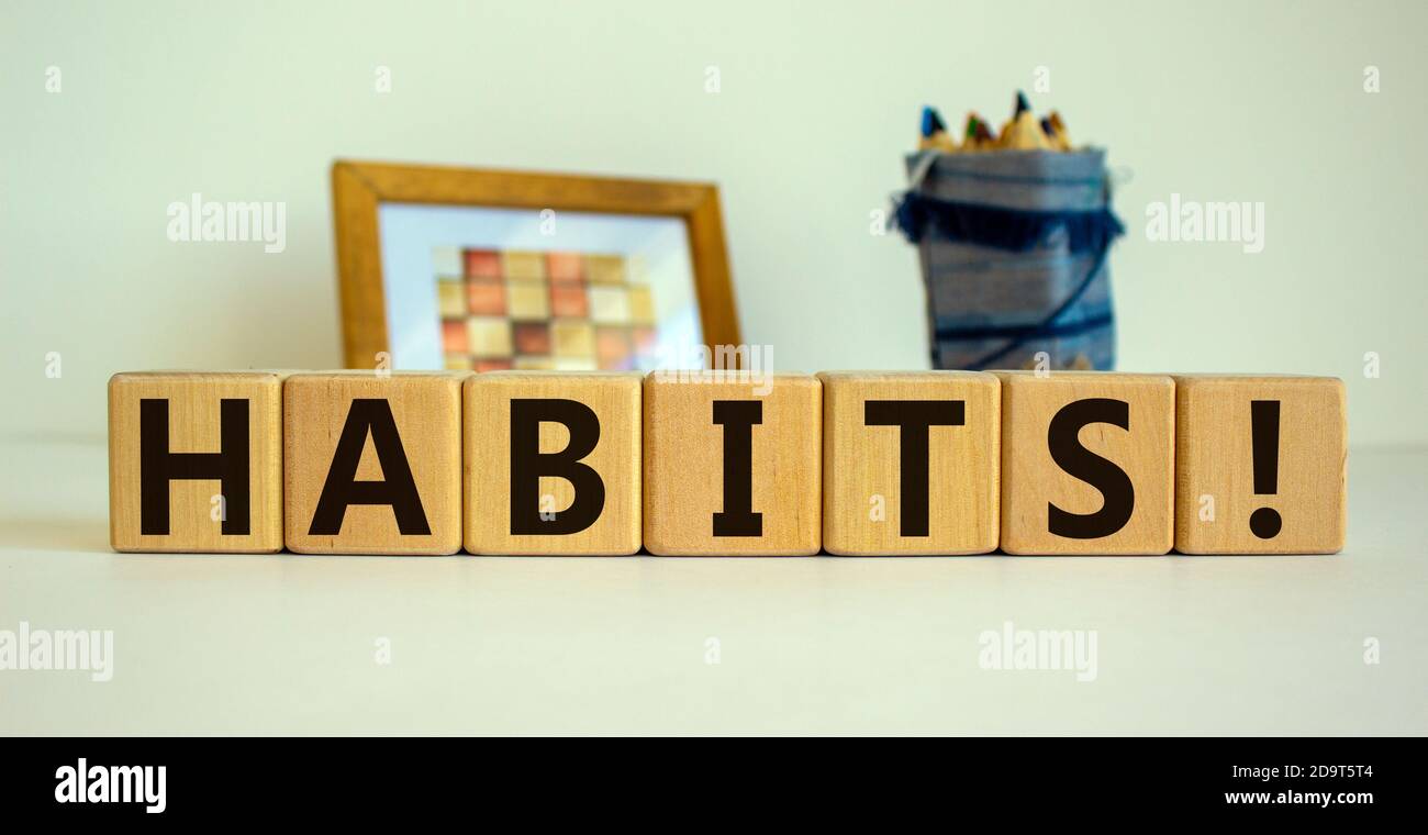 Wooden cubes with the expression 'habits'. Bag with pencils, frame ...