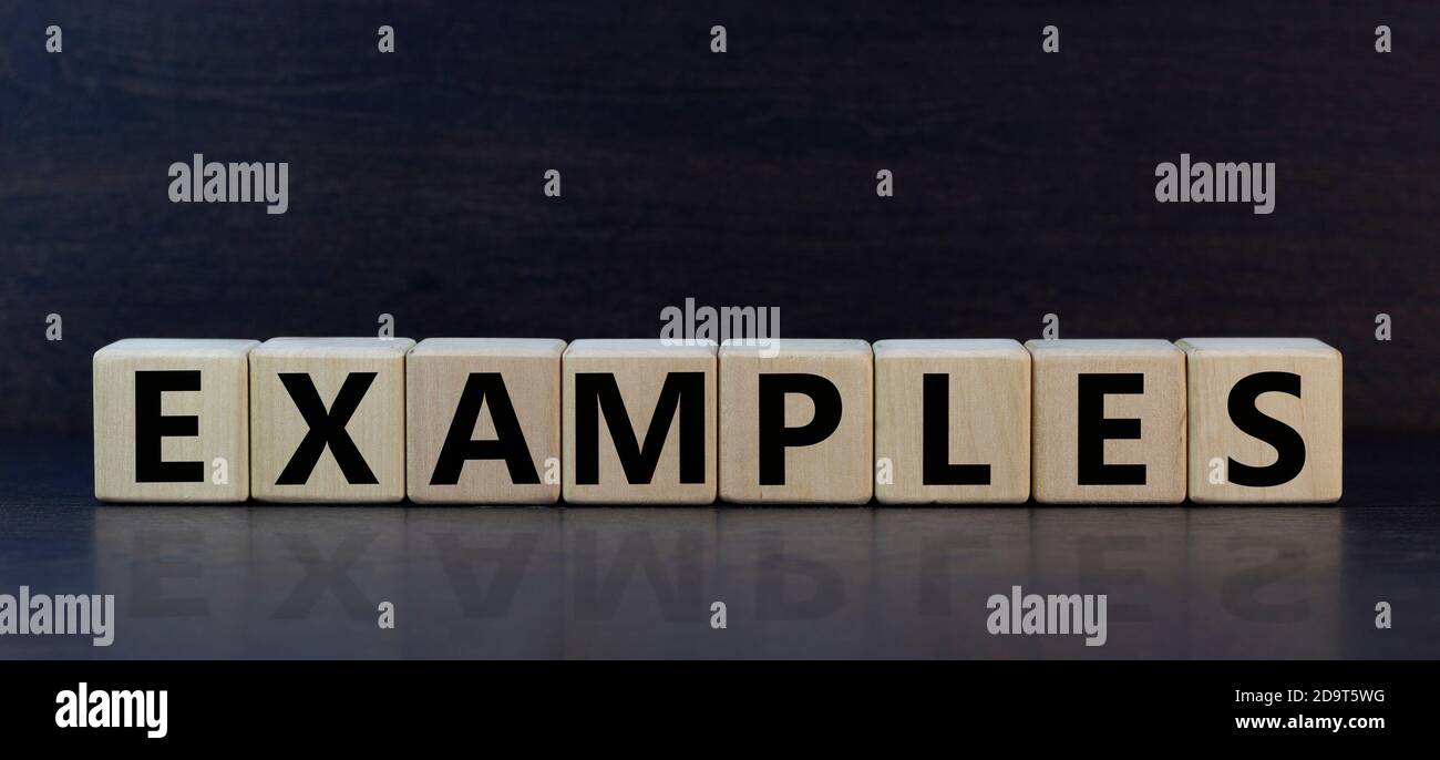 Concept word 'examples' on wooden cubes on a beautiful darl wooden ...
