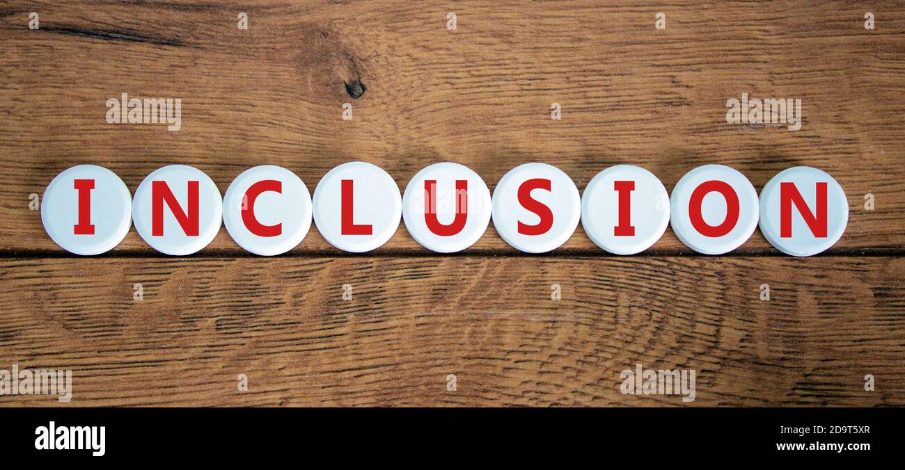 Symbol for a better inclusion. Wooden circles with word 'inclusion ...