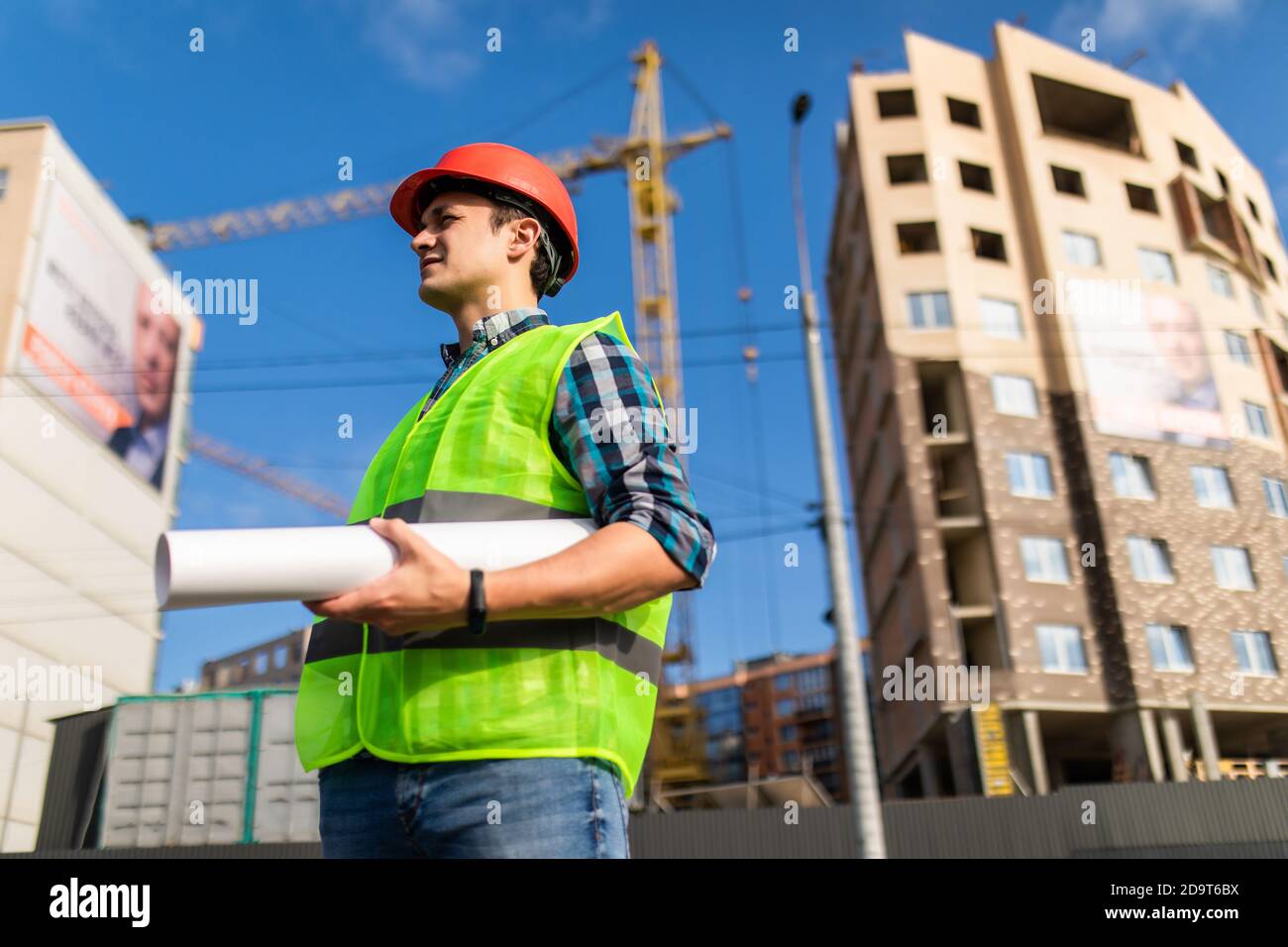 engineer builder with blueprint plan at construction site Stock Photo ...
