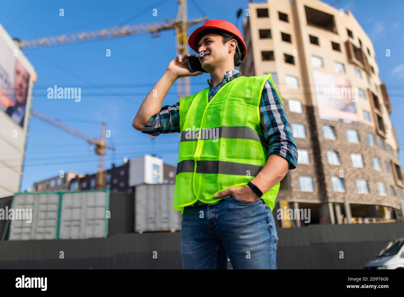 Engineer talking on the phone on a construction site Stock Photo - Alamy