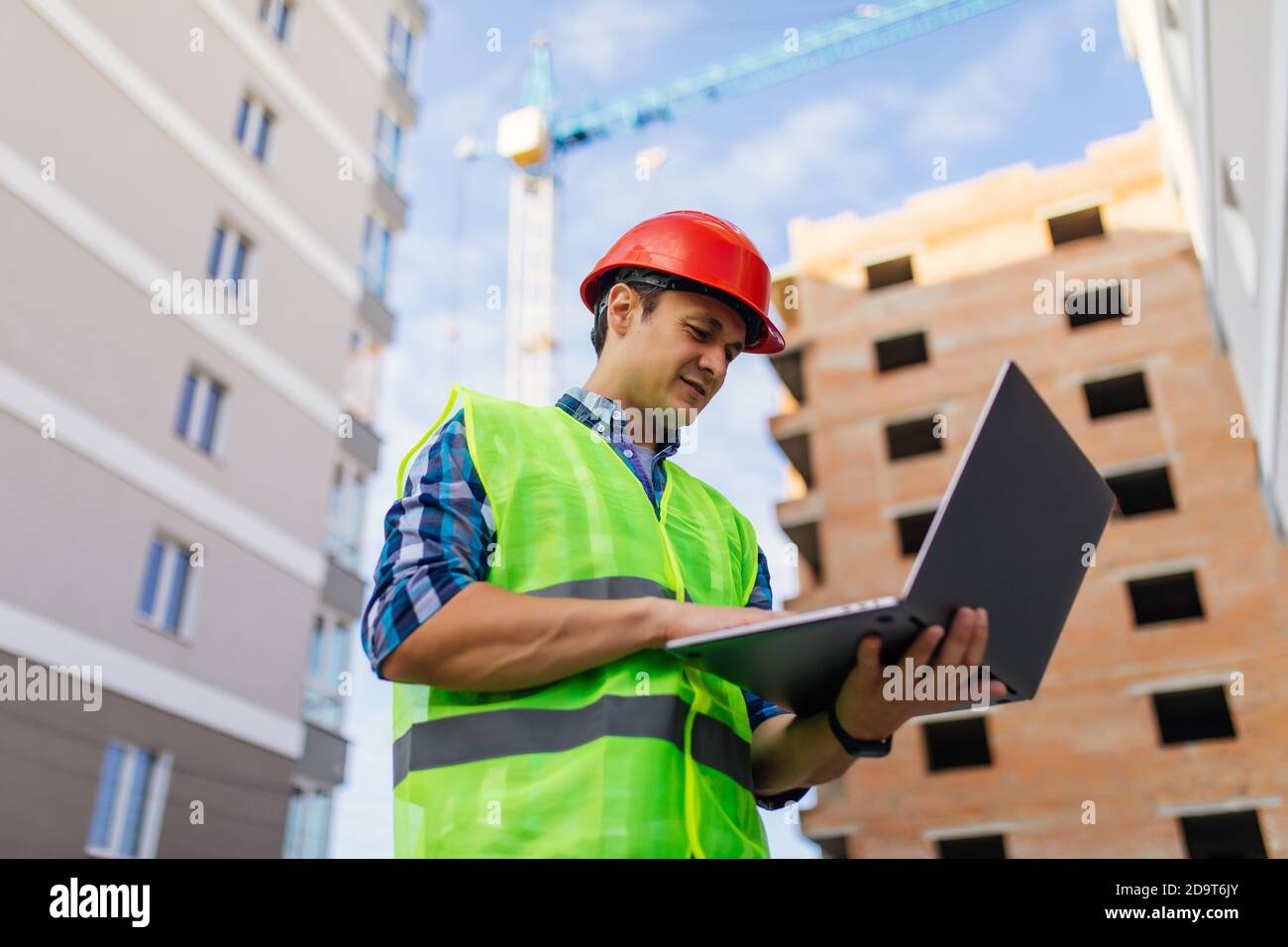 engineer with laptop computer at construction site Stock Photo - Alamy