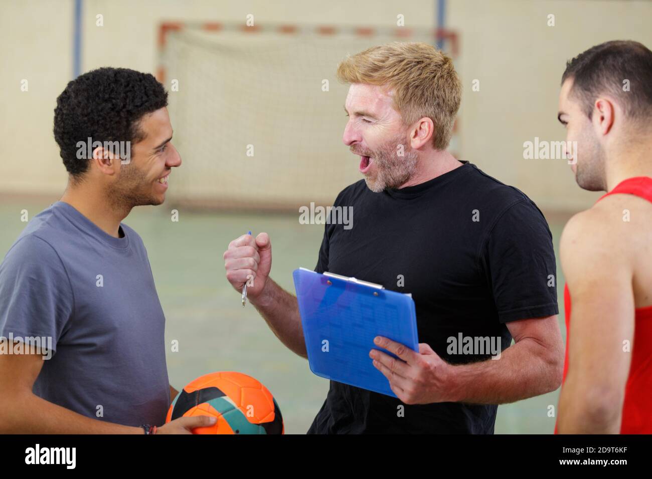 football coach shouting orders his teammates Stock Photo - Alamy