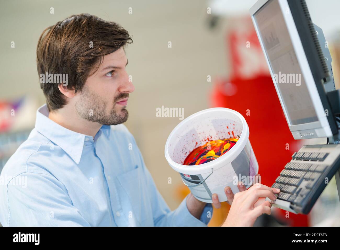 paint production engineer checking information in computer Stock Photo ...
