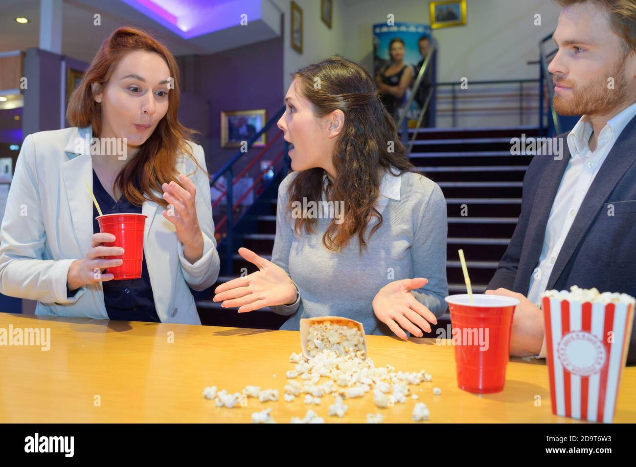 friend angry cause her popcorn fell on the table Stock Photo - Alamy