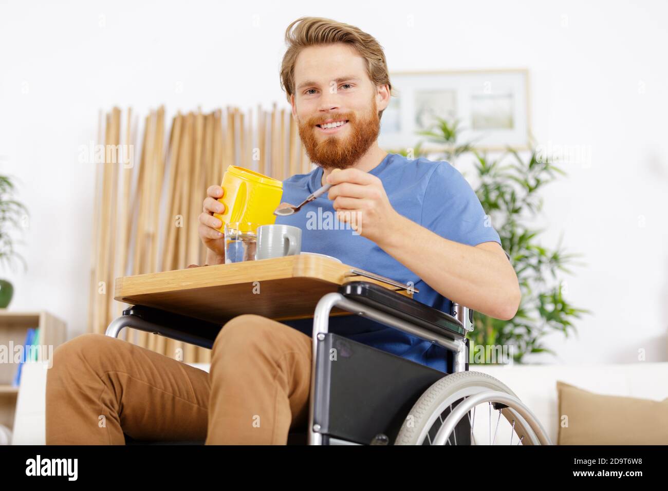 male in wheelchair having a hot chocolate Stock Photo - Alamy