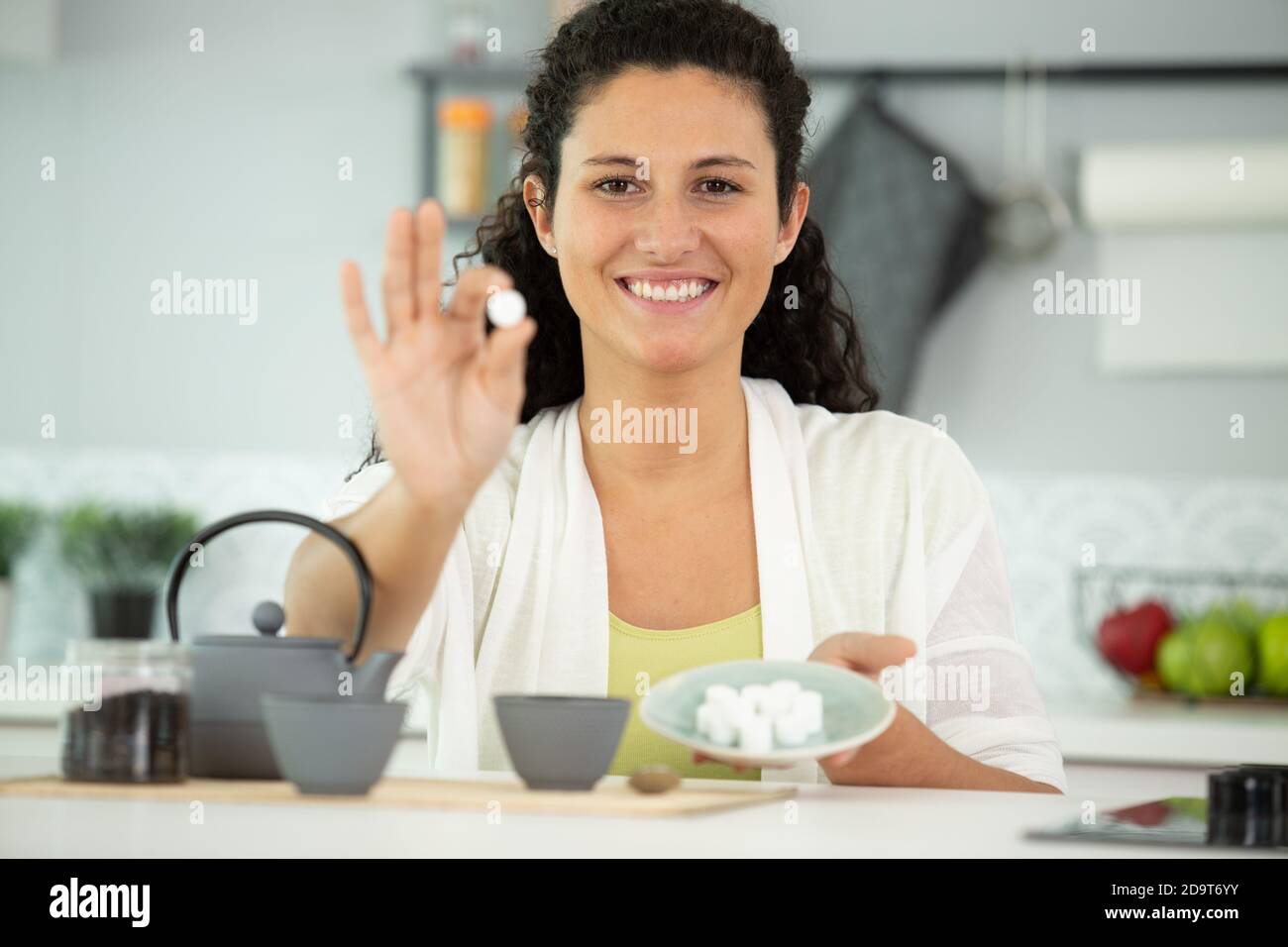 young beautiful woman showing sugar Stock Photo - Alamy