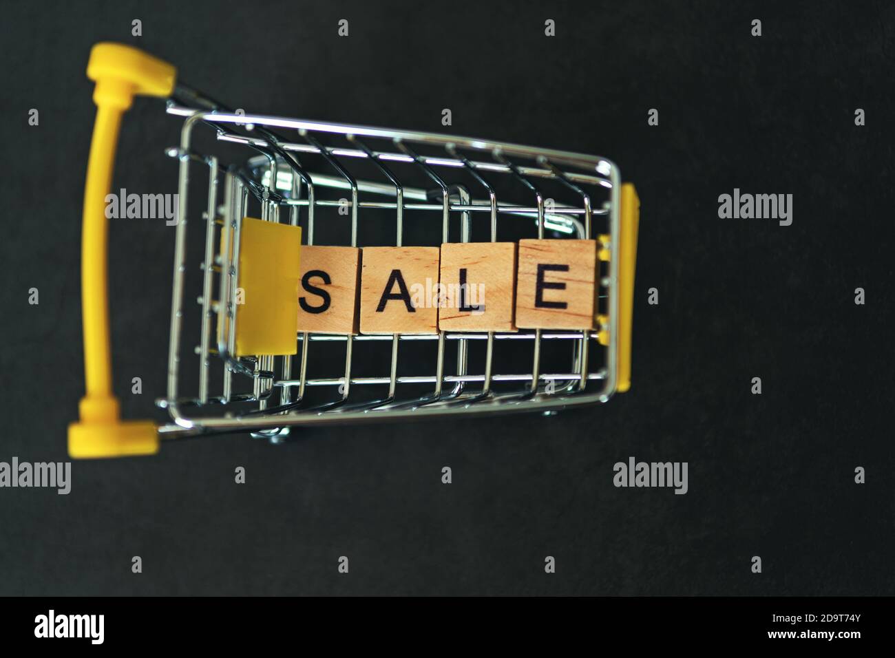 Season of sales in online stores. Cart and sales word on dark blue ...