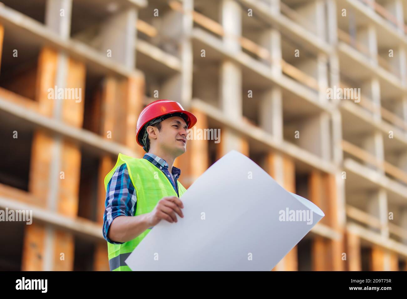 View of an Engineer worker checking plan on construction site Stock ...