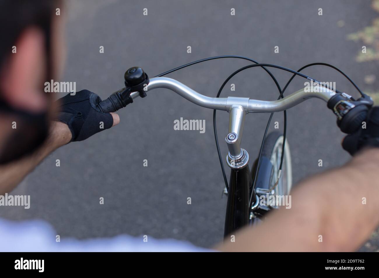 close up man hands on bicycle handle bars Stock Photo - Alamy