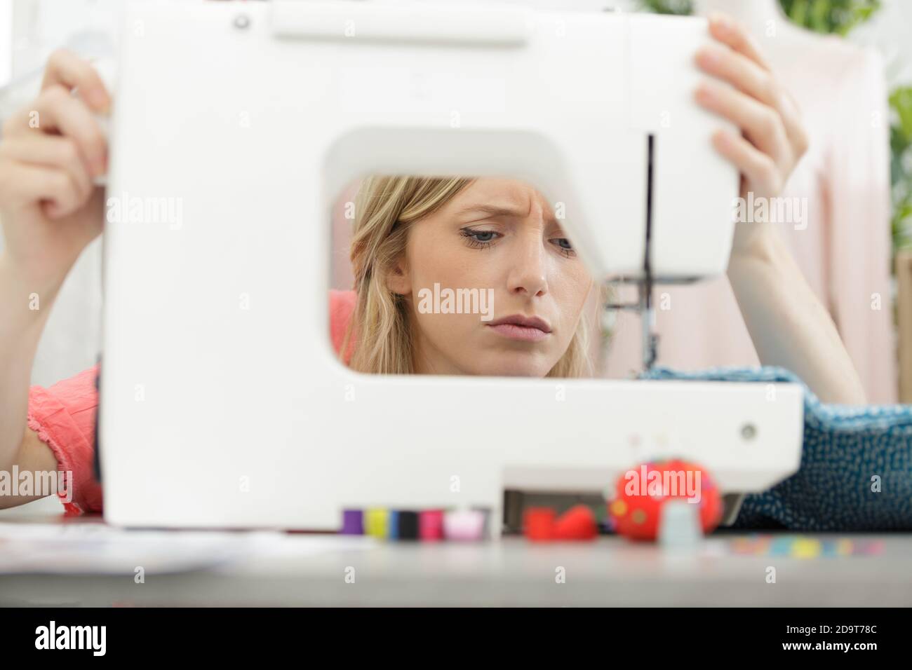 young woman sewing with sewing machine Stock Photo - Alamy