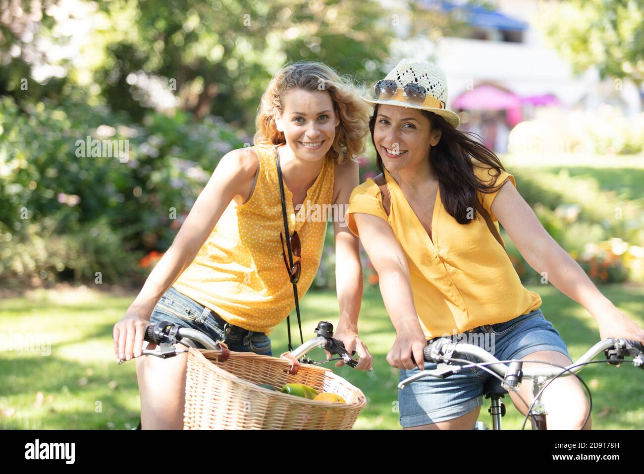 two friends on bikes outdoors smiling Stock Photo - Alamy