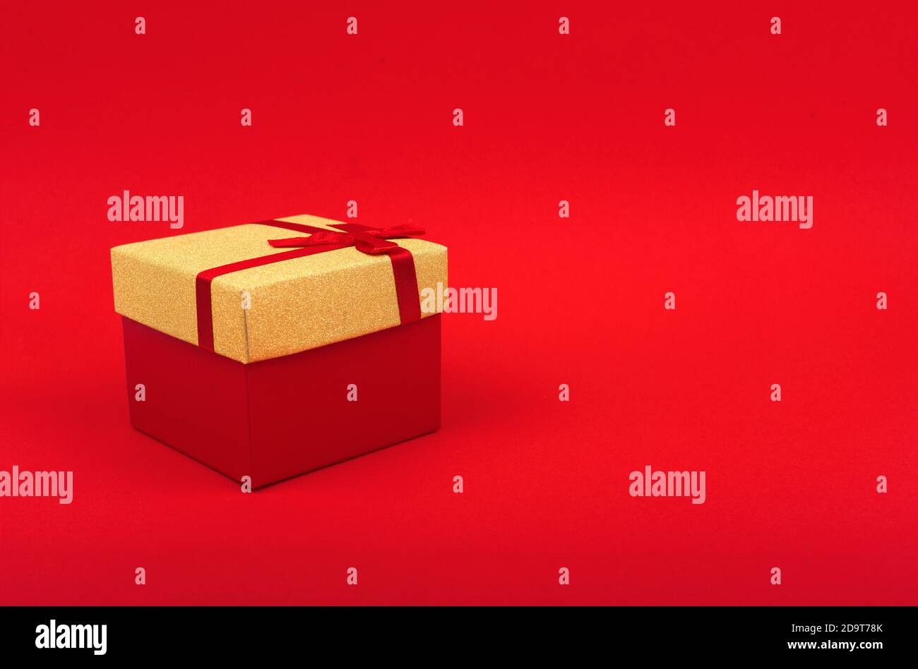 red square gift box with gold cover on red background, minimalism, new ...