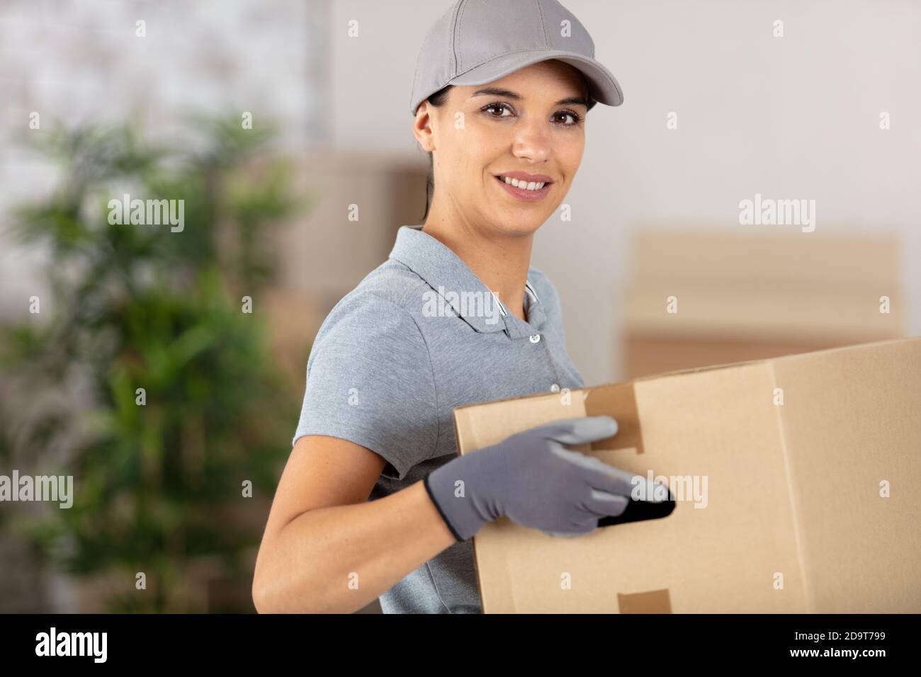 delivery service concept delivery woman holding box Stock Photo - Alamy